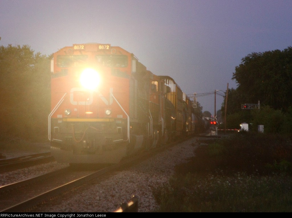 CN 8872's headlight cuts through the evening mist